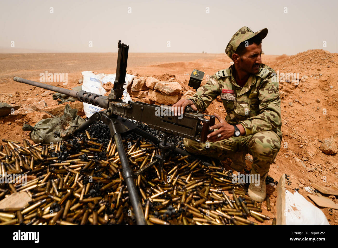 A Jordanian special forces Soldier sits next to a .50 caliber machine ...