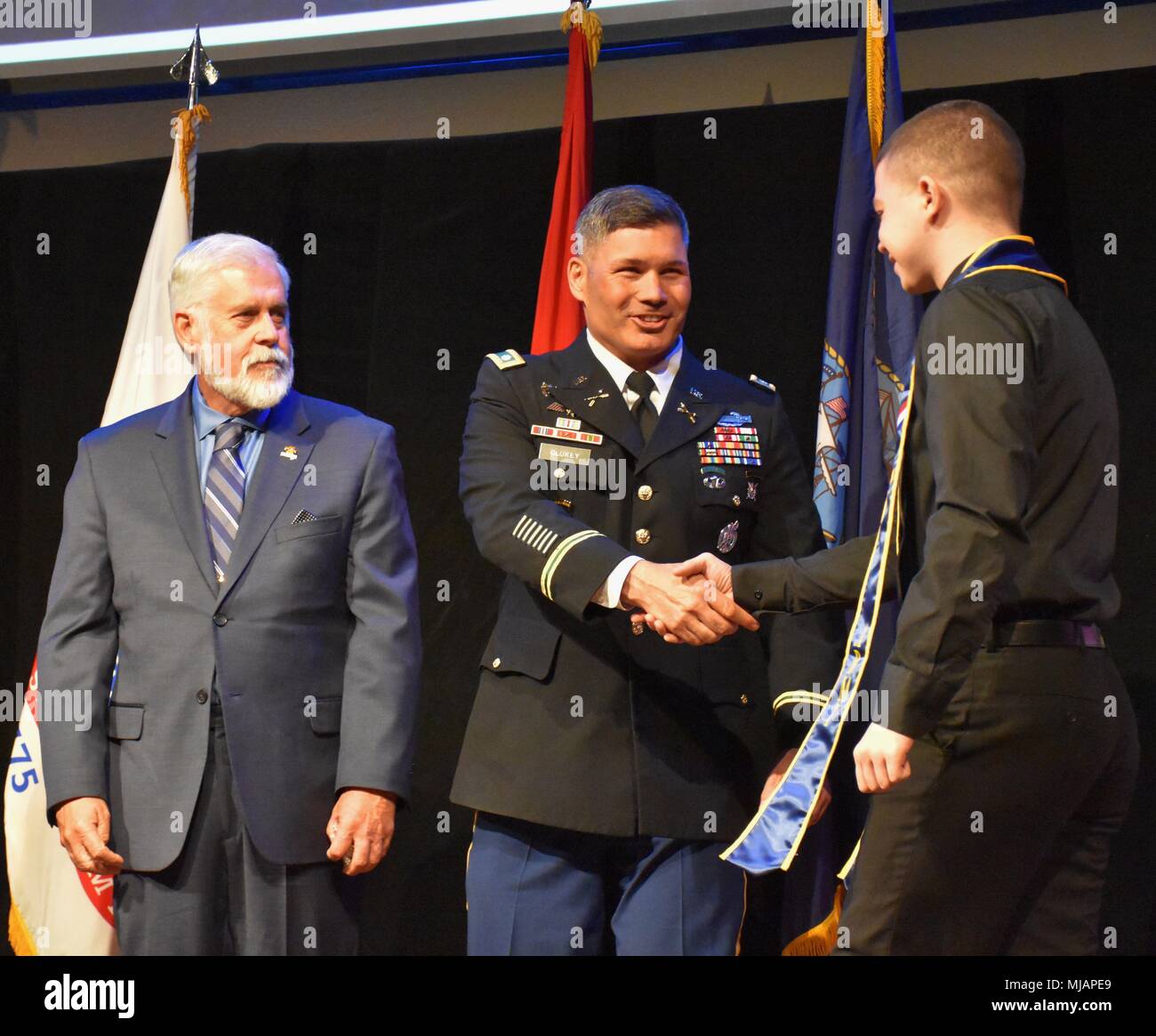 Watched by Glendale Mayor Jerry Weiers (left), Lt. Col. David Clukey ...