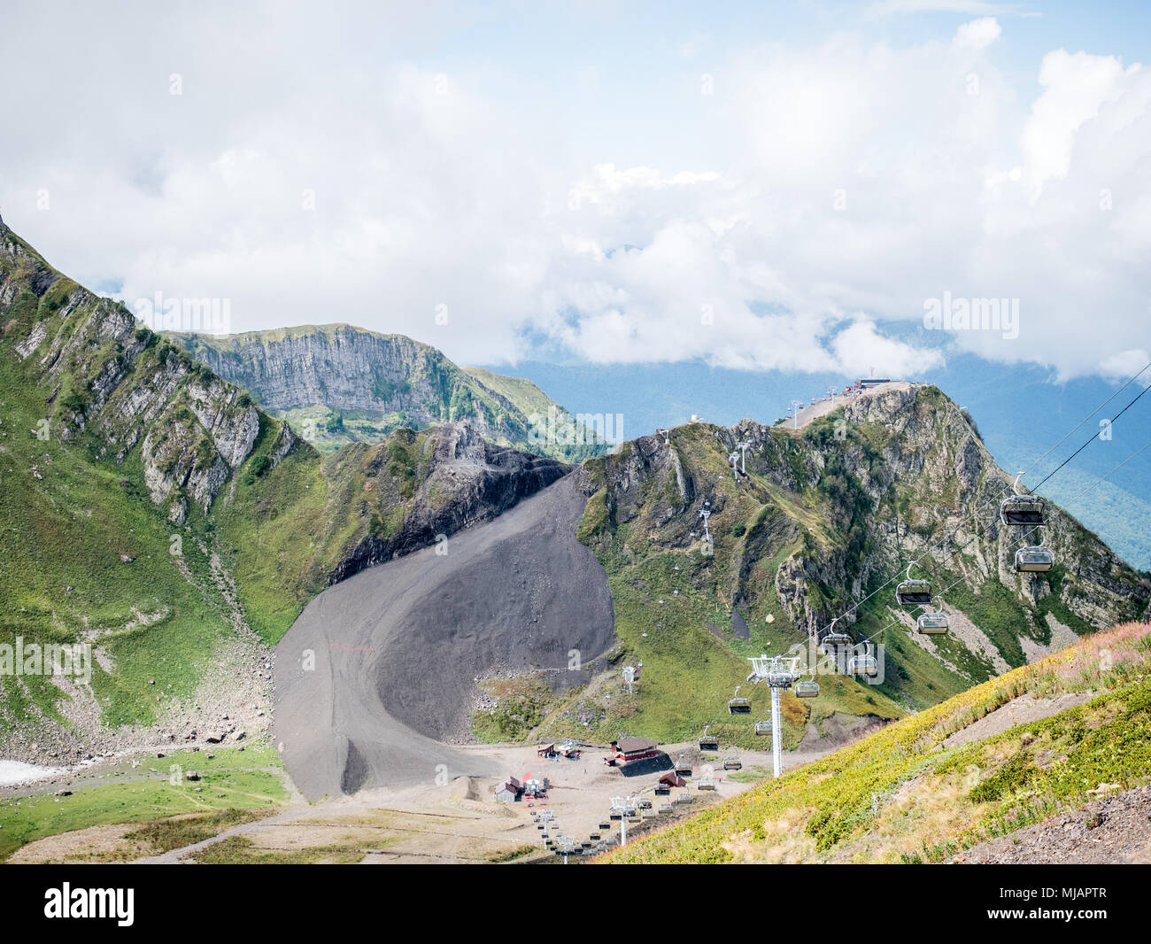 Photo of mountain slopes with vegetation and cloudy sky Stock Photo - Alamy