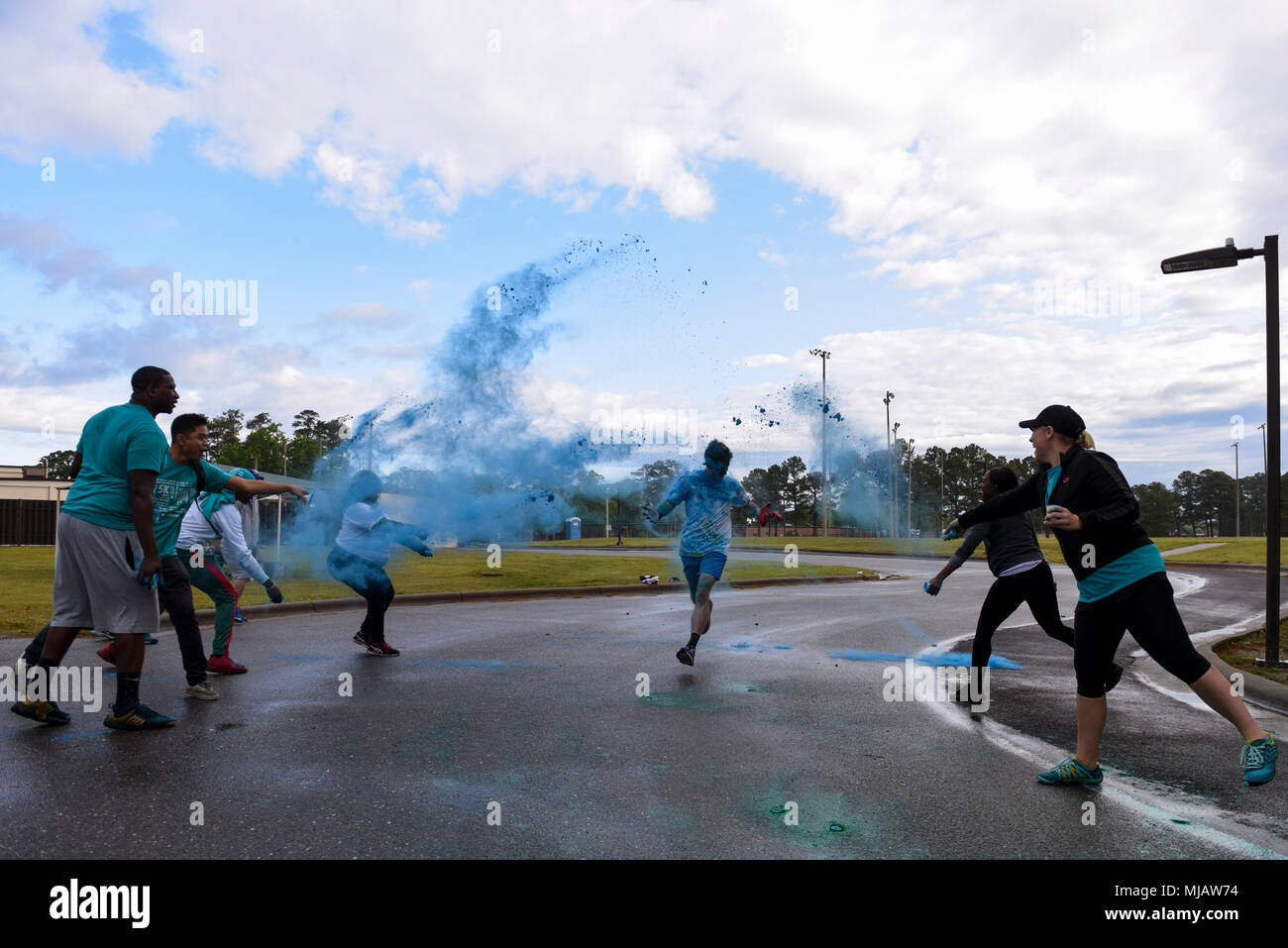 A runner gets doused with a colorful powder during a “Diversity Dash ...