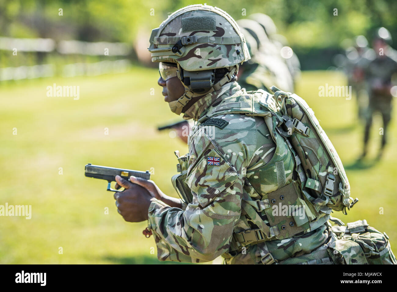 British Royal Air Force soldier prepares to fire his Glock 17 on range ...
