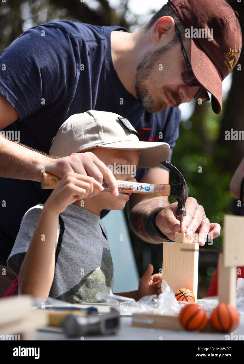 Austin Herrera and his son, Nolan, assemble a miniature wooden ...