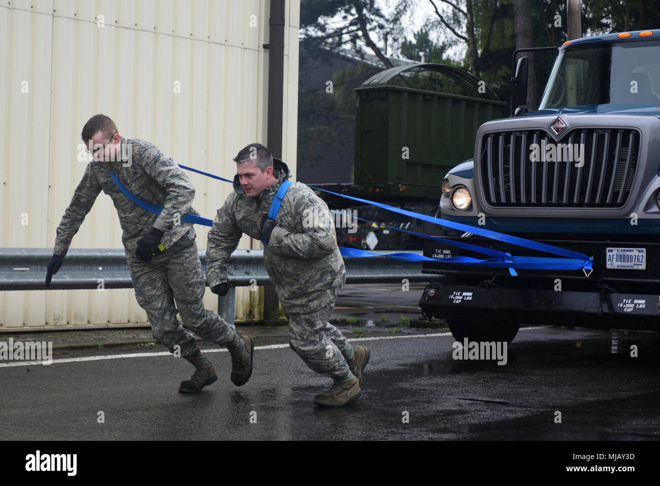Airmen from the 100th Logistics Readiness Squadron pull a tractor ...