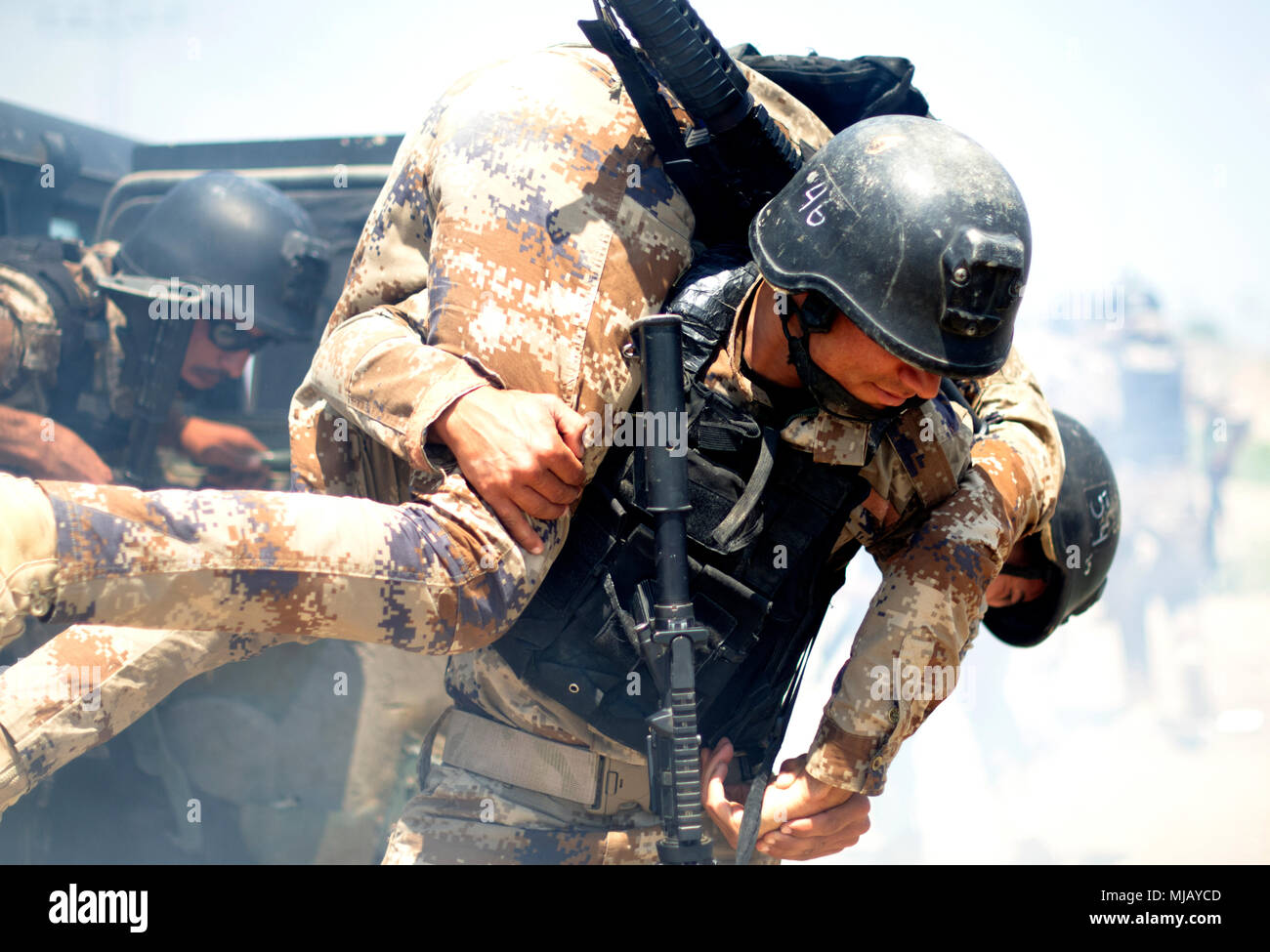 SOUTHWEST ASIA – An Iraqi Counter Terrorism student carries his comrade ...