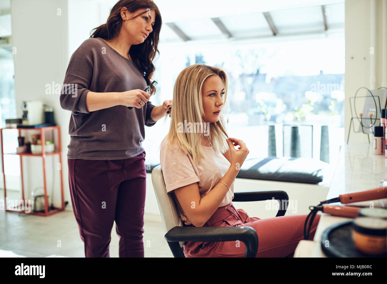Young woman getting her hair done salon hi-res stock photography and ...