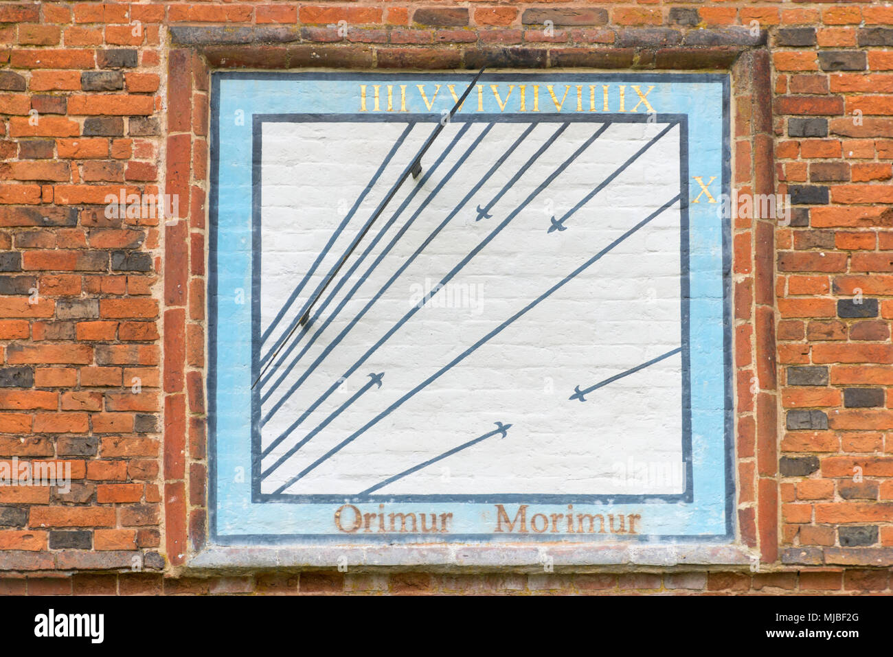 square blue and gold sun dial with roman numerals and words orimur ...