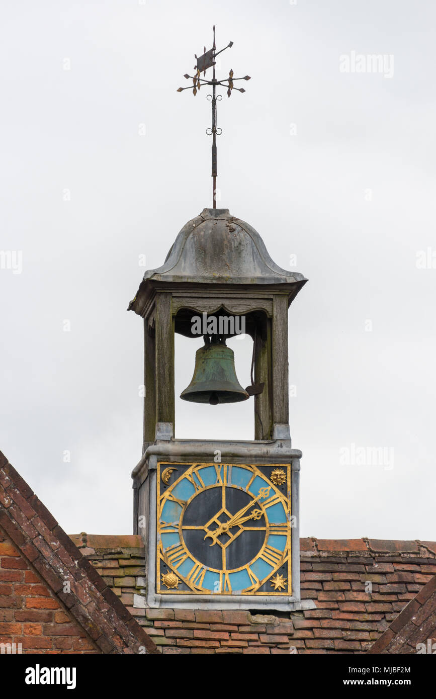 ancient ornate blue and gold clock tower with bell and weather vane ...