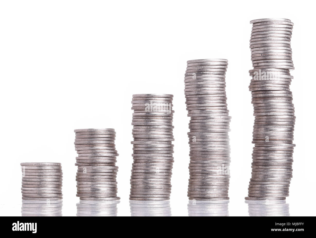 Five unstable stacks of coins in rising succession on a white ...