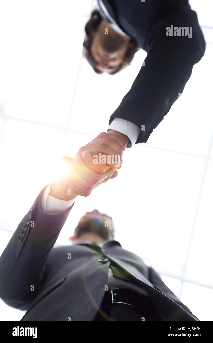 handshake in office, bottom view Stock Photo - Alamy