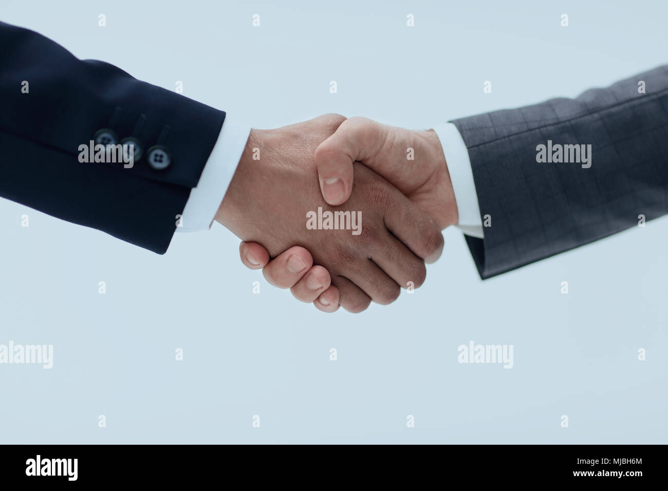 Business handshake - closing a deal on a gray background Stock Photo ...