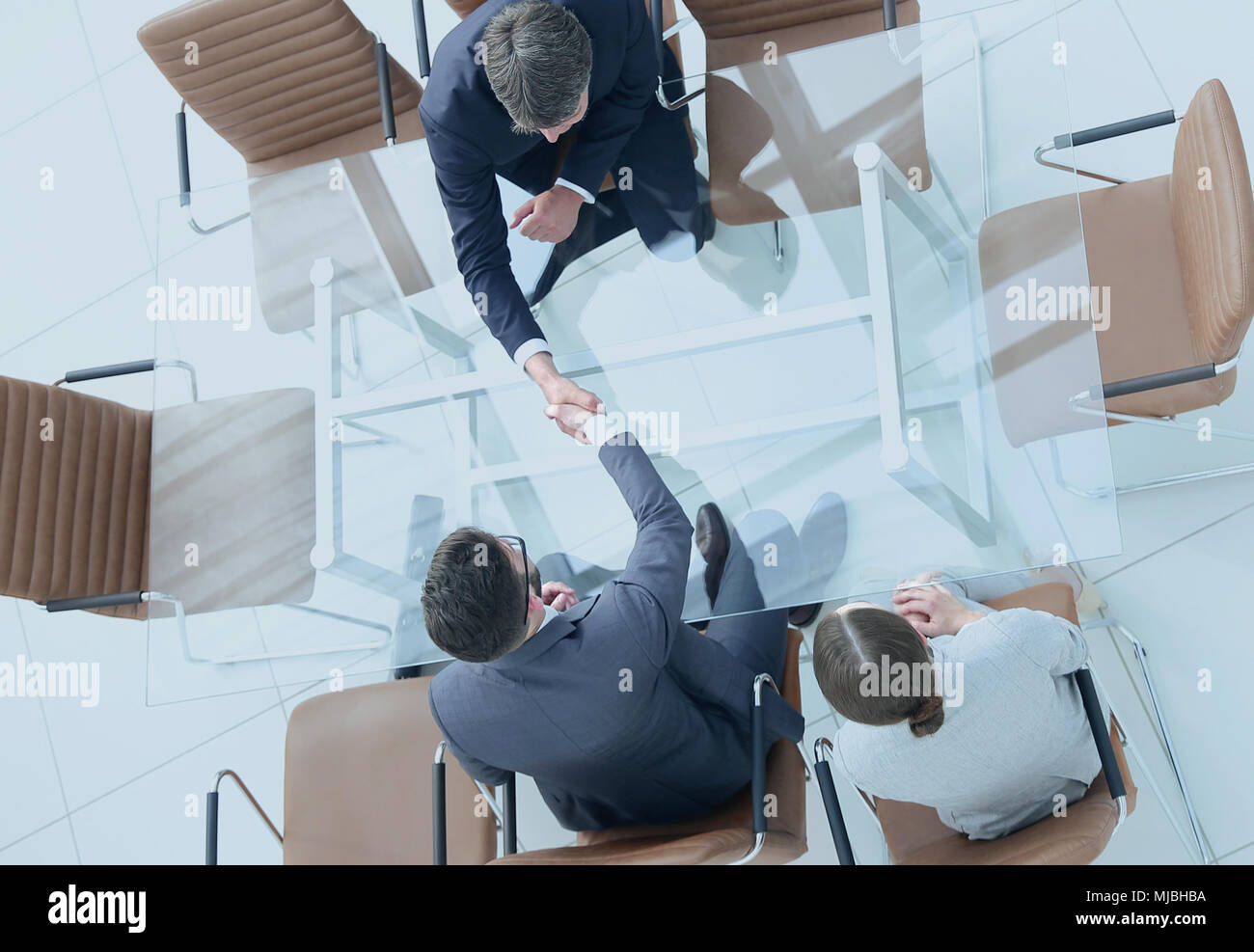Top view Handshake across the table. Meeting in the conference room ...