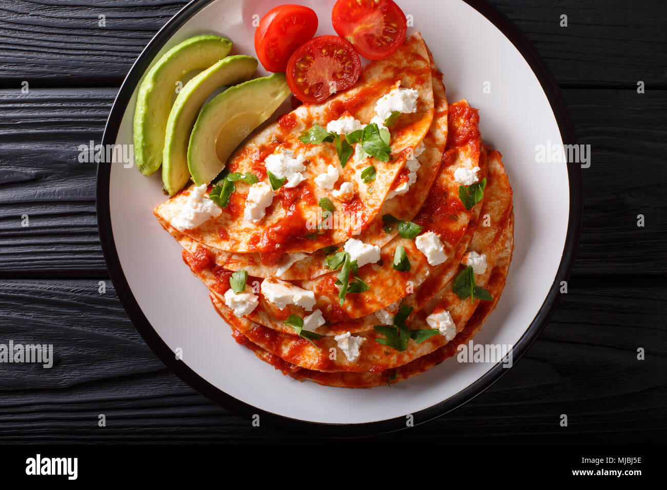 Mexican food: entomatadas with farm cheese, tomato sauce, greens and ...