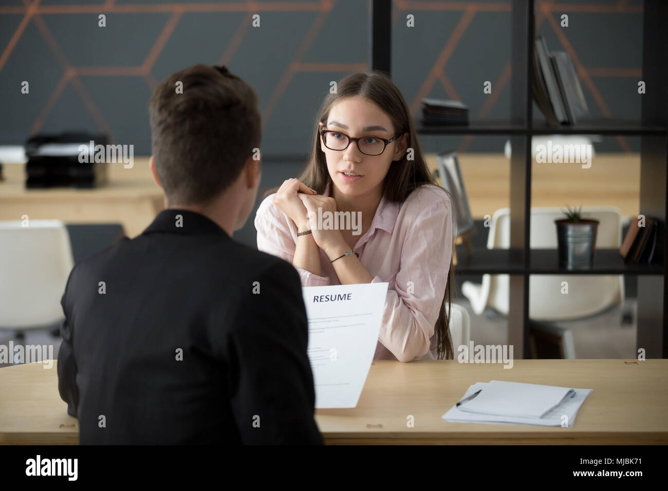 Confident millennial female applicant talking at job interview a Stock ...