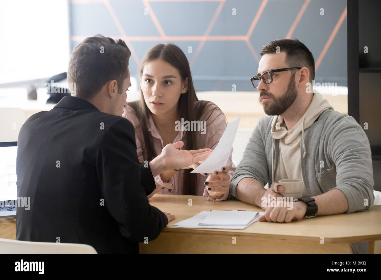 Angry millennial couple complaining about bad contract disputing Stock ...