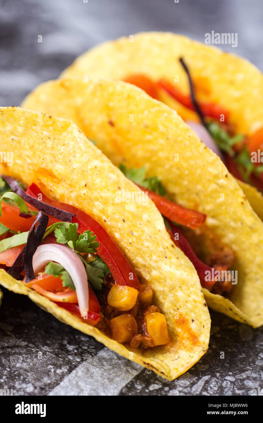 Three Colorful Mexican Tacos in Shells on Stone Background Stock Photo ...