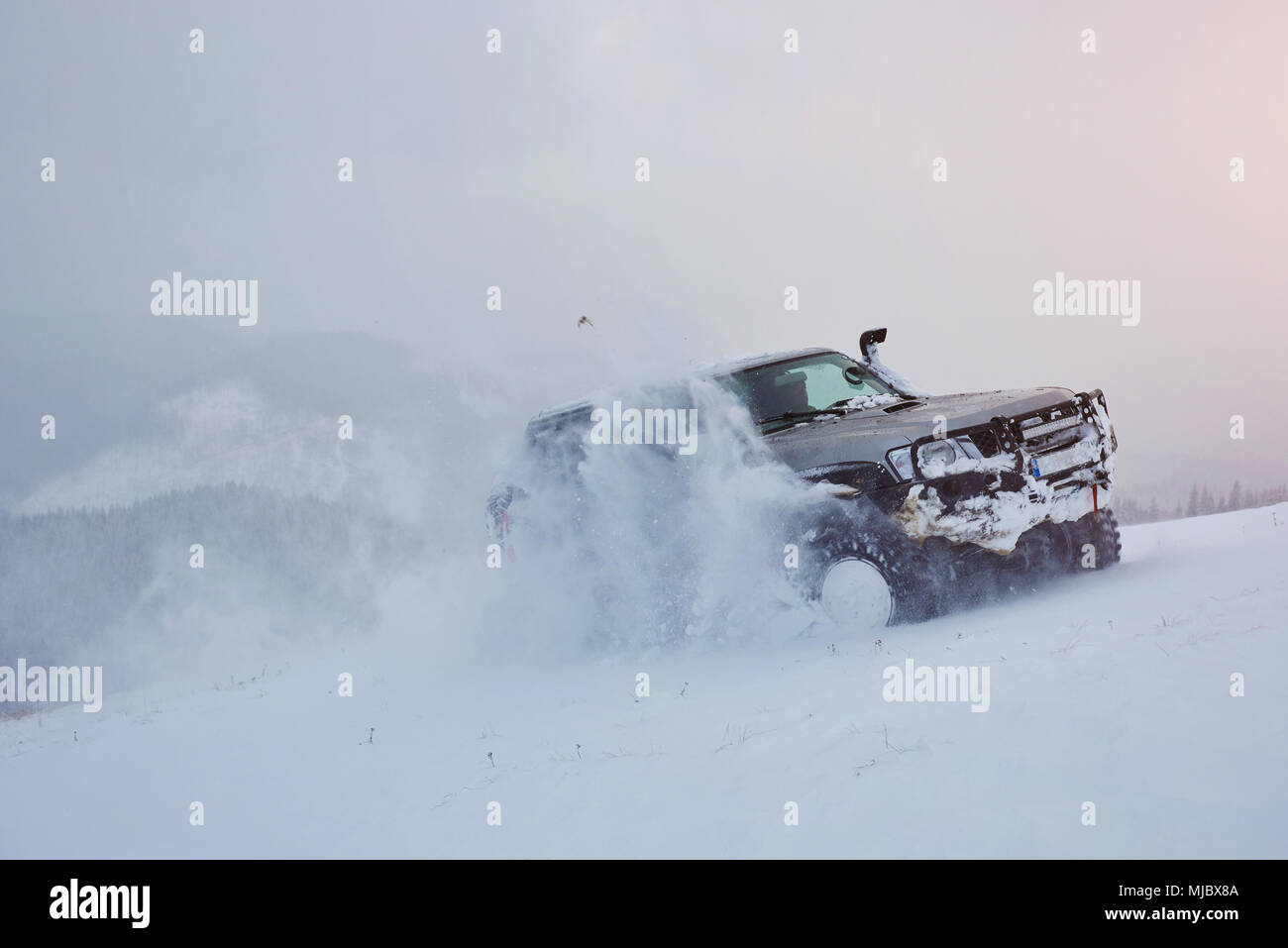 SUV rides on a winter mountians driving risk of snow and ice, drifting ...