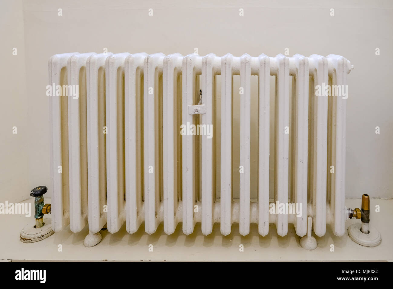 Metal radiator, old and painted in white but still functional Stock ...