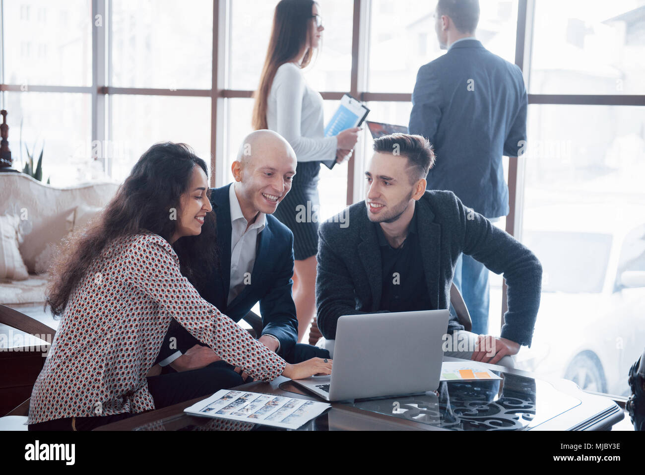 Young team of coworkers making great business discussion in modern ...