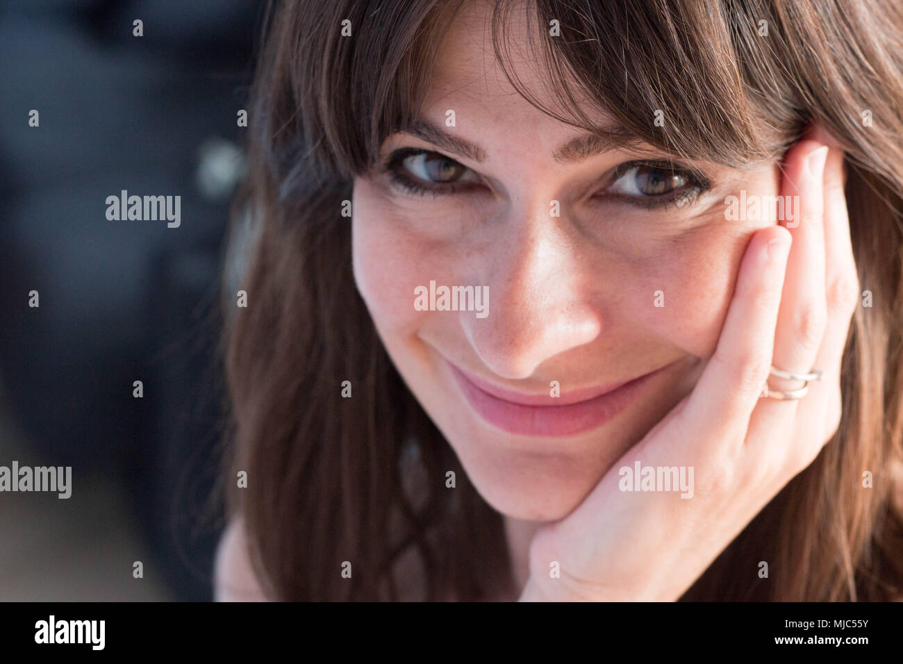 close up portrait of caucasian young woman with long hair and bangs ...
