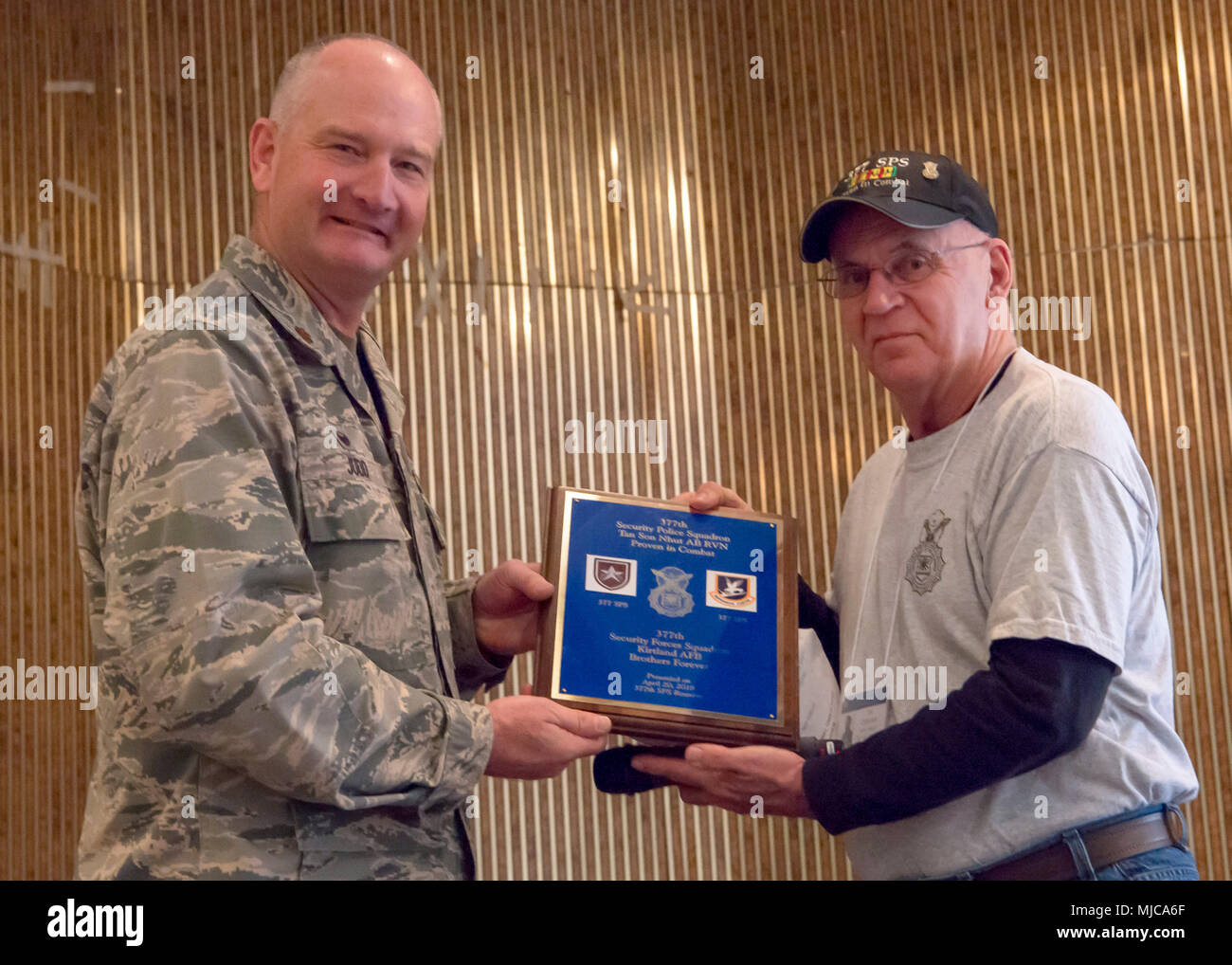 377th Security Forces Squadron Commander Maj. Eric Judd (left) receives ...