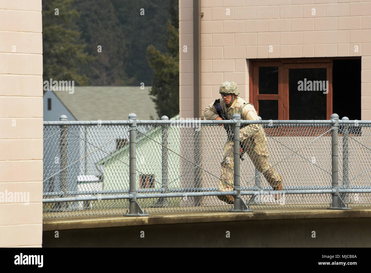 U.S. Army Soldiers play the role of enemy combatants as they move to ...