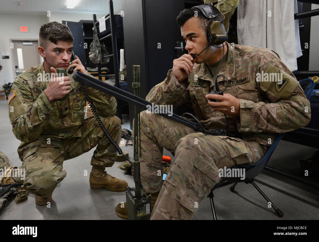 Oregon Army National Guard Spc. Tyler Takagi (right), assigned as a ...