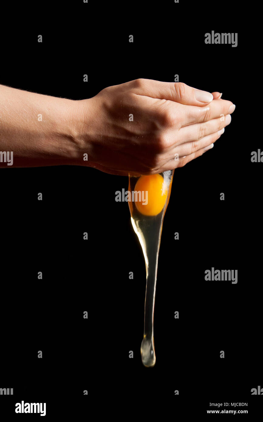 raw egg falling down out of hands Stock Photo - Alamy