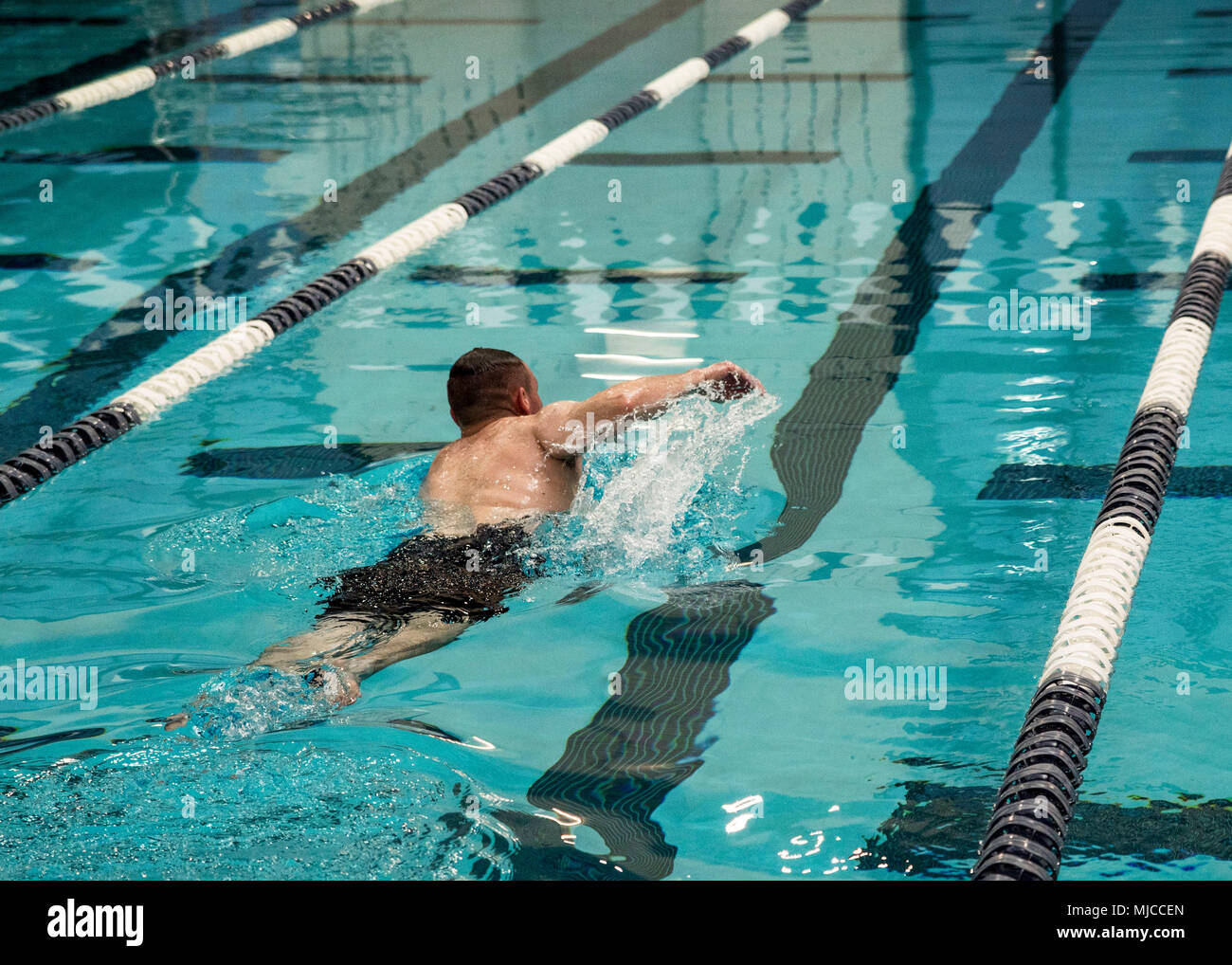 Hospitalman Eric Alter swims laps in the Naval Support Activity ...
