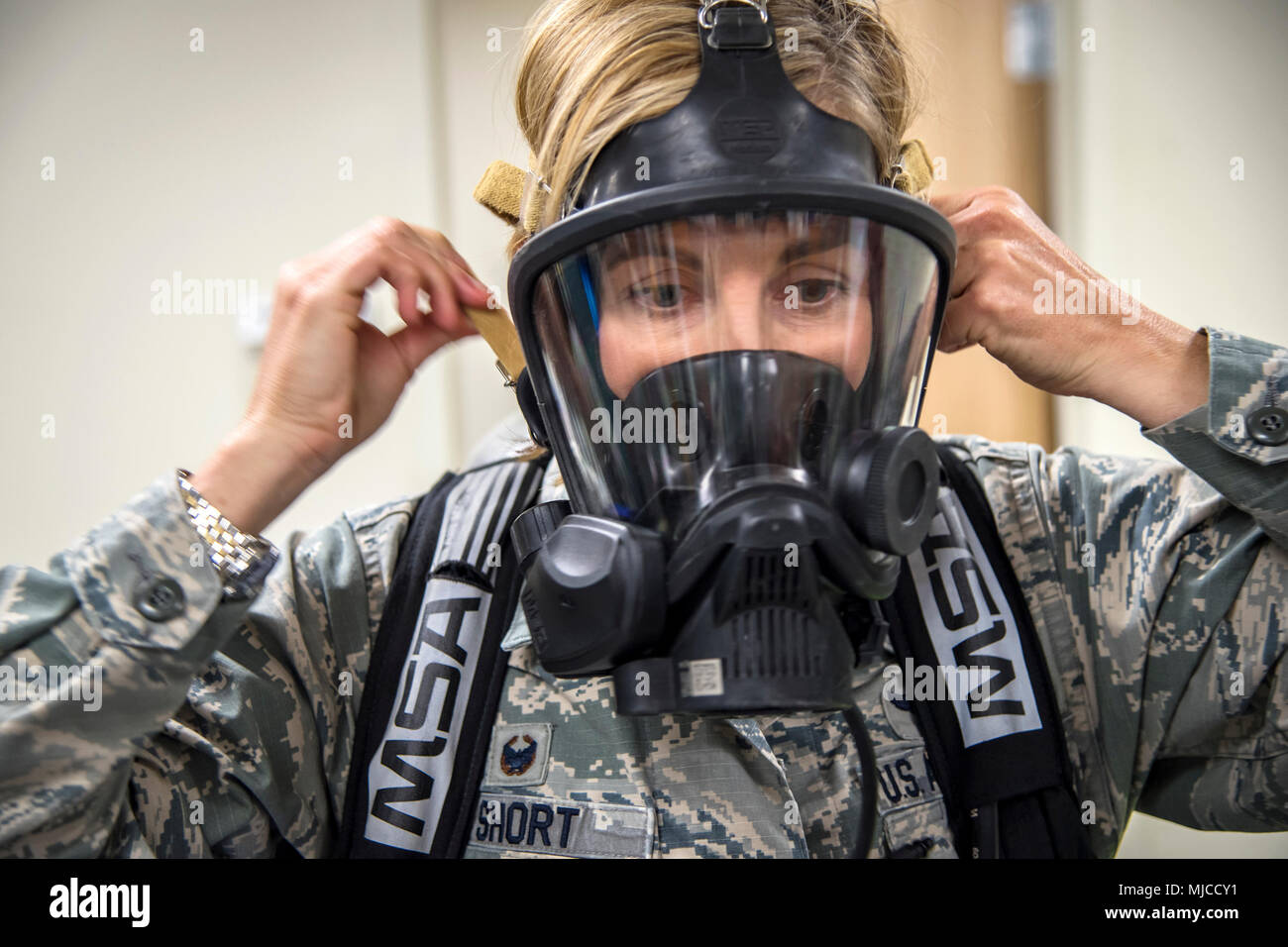 Col. Jennifer Short, 23d Wing commander, tightens a gas mask, April 30 ...