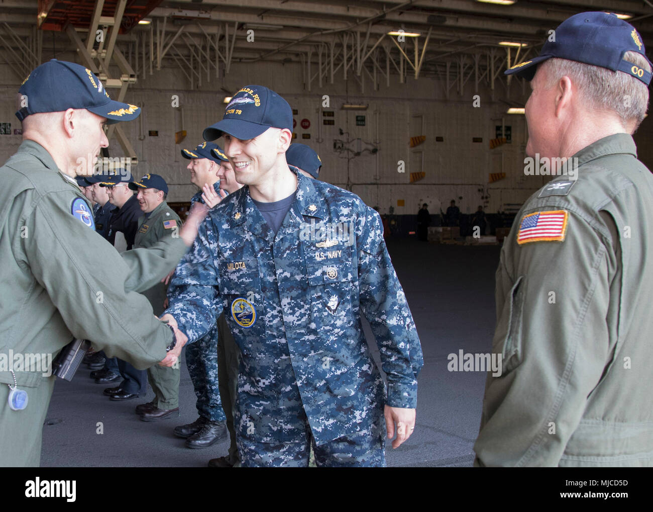 NORFOLK, Va. (May 1, 2018) -- Lt. Cmdr. Jeffrey Milota shakes hands ...
