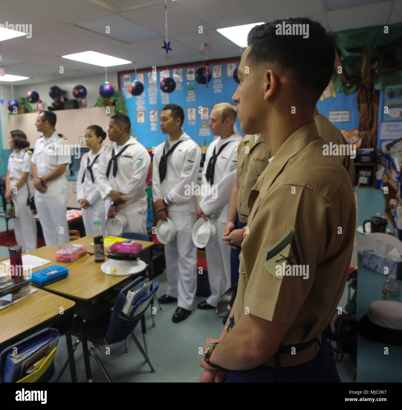 U.S. Marines and Sailors form a half circle and introduce themselves to ...