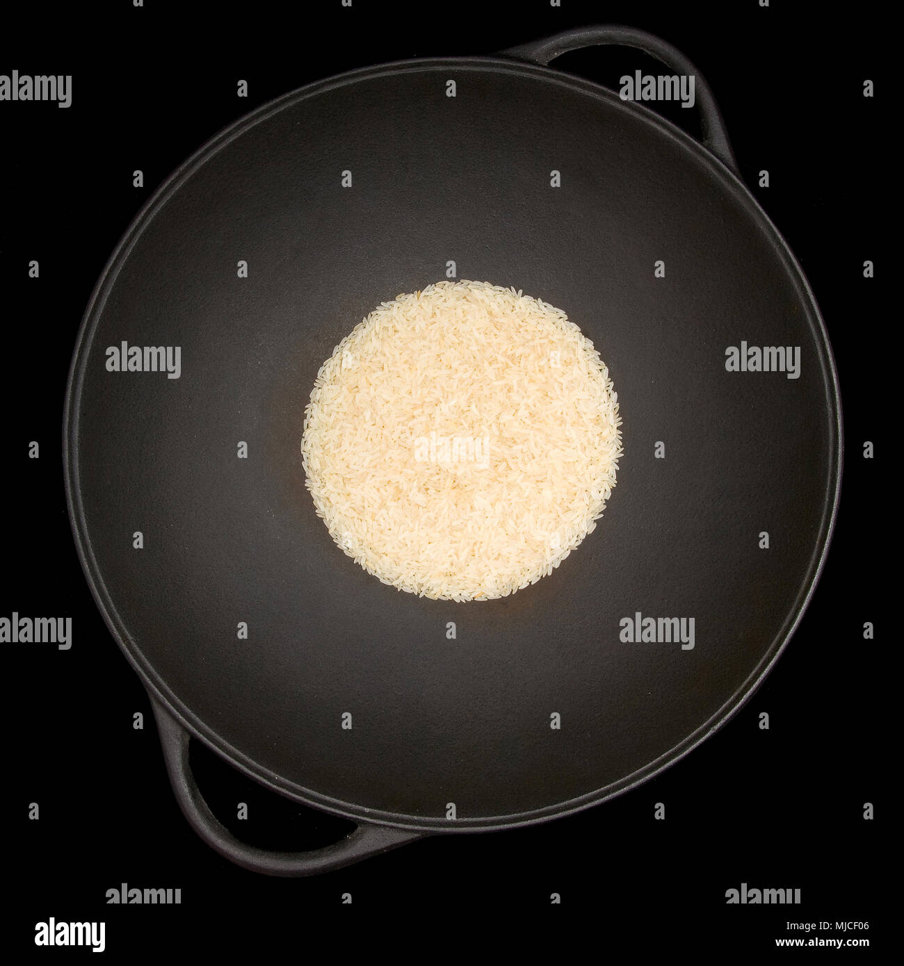 wok and rice on black background Stock Photo - Alamy