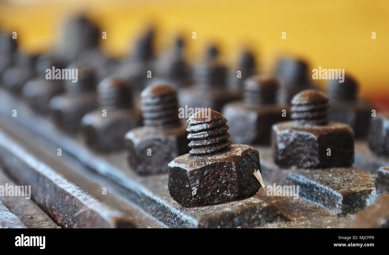 Old vintage rusty bolts with nuts on great metal plate. This image was ...