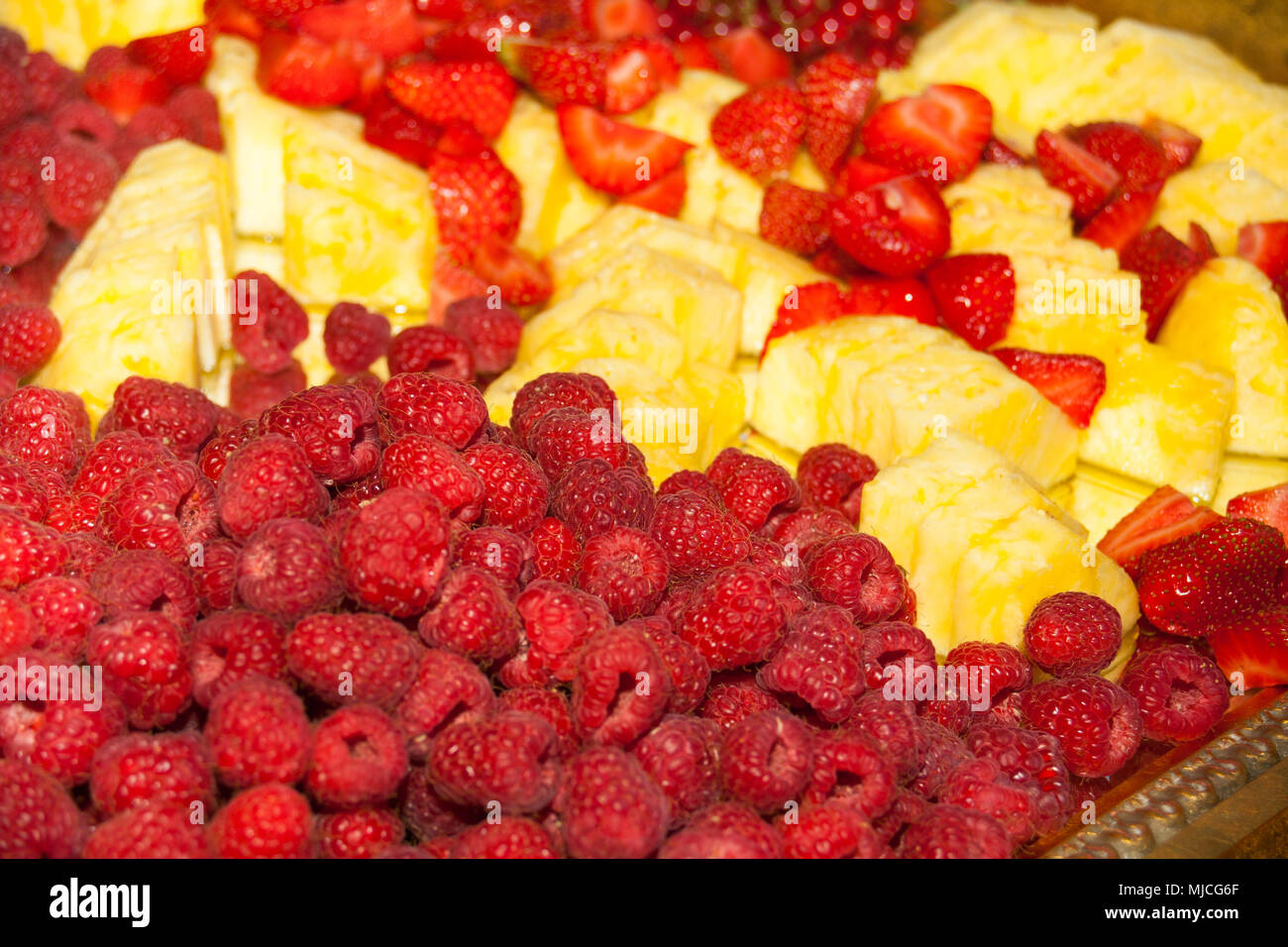 raspberry and pineapple, red and yellow colors Stock Photo - Alamy