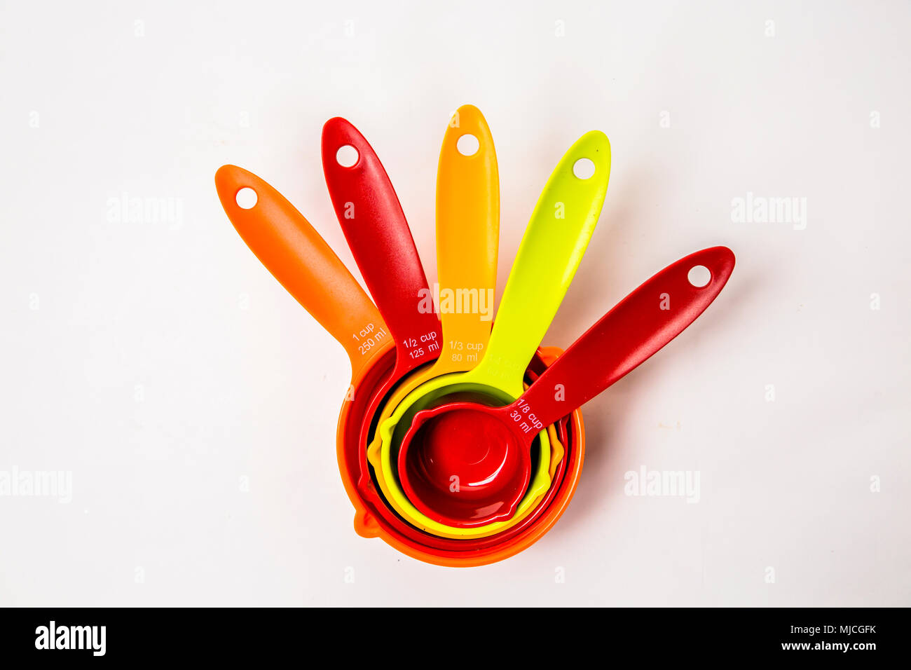 Colorful measuring cups in whitebackground Stock Photo - Alamy