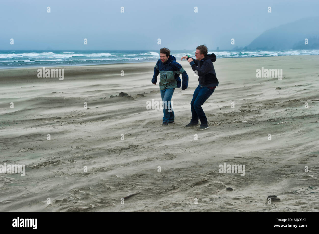 Two brothers brave the windy cold wet weather at Cannon Beach on the ...