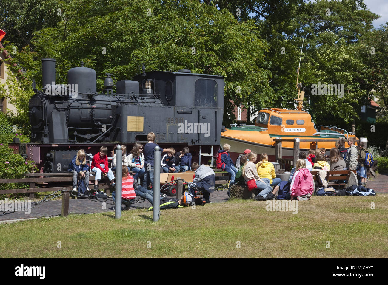 Lifeboat and steam engine with the old lighthouse hi-res stock ...