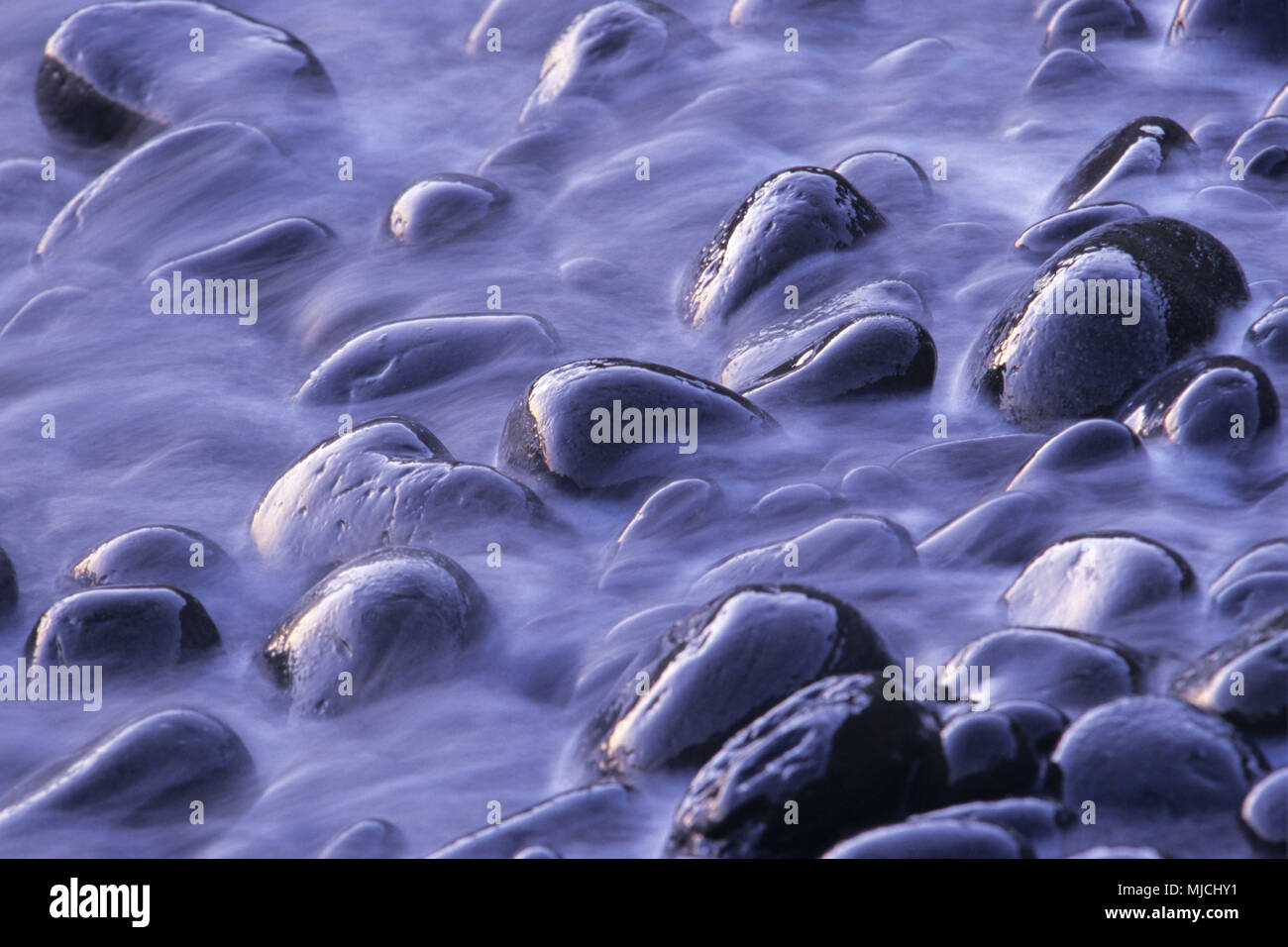 Sea washes around stones at the beach hi-res stock photography and ...