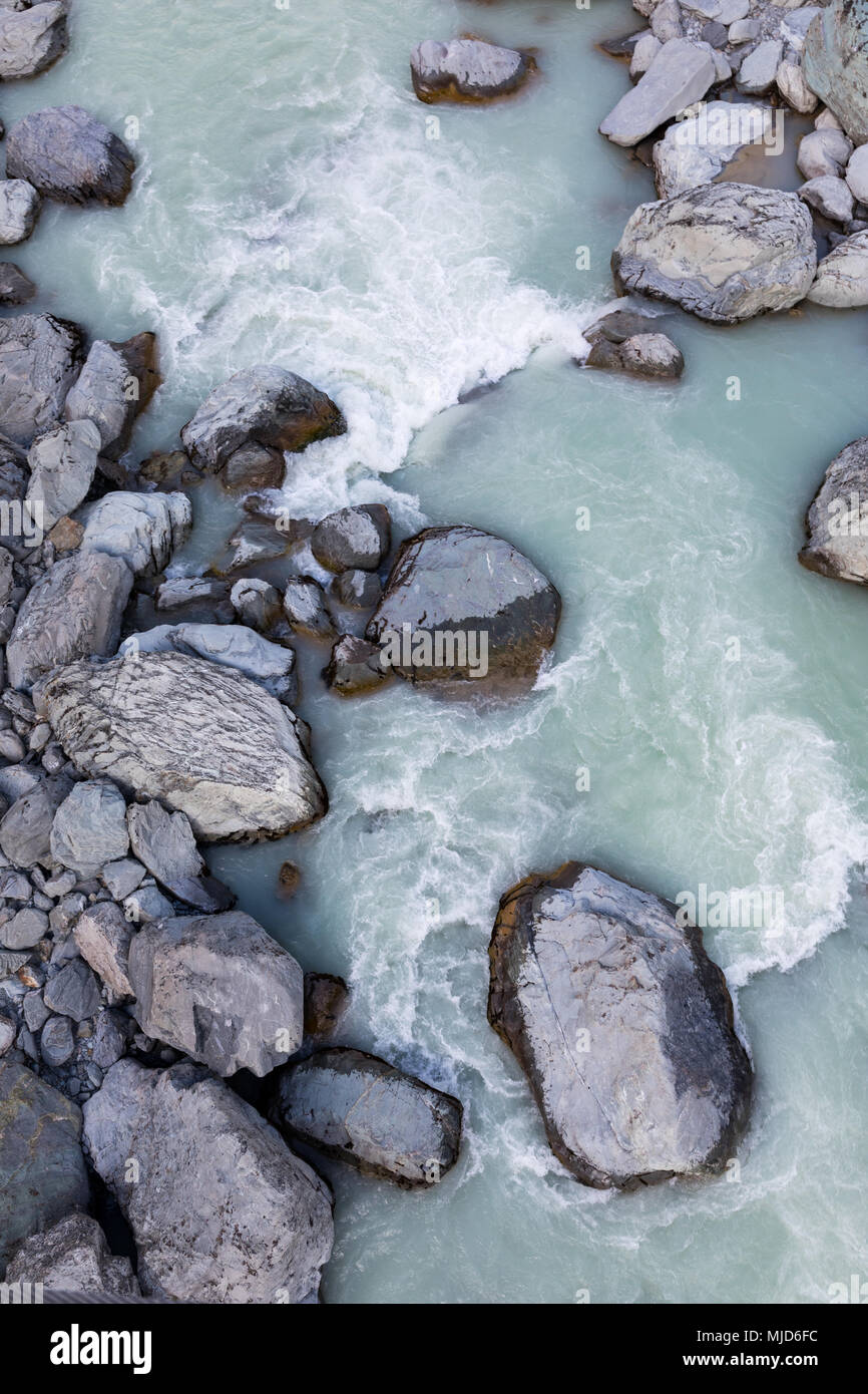 Overhead view of alpine rocks and stream with glacial water, Mount Cook ...