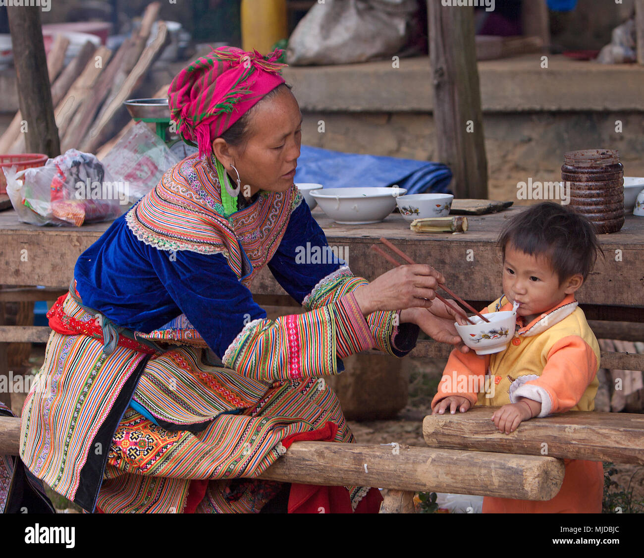 Hmong woman weaving with dried grass inat Can Cao market, in Vietnam ...