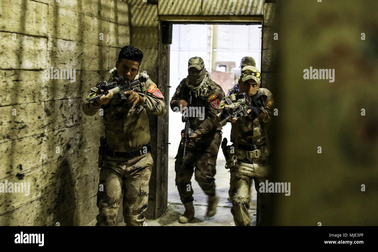Iraqi Counter Terrorist Forces soldiers maneuver through a hallway in a ...