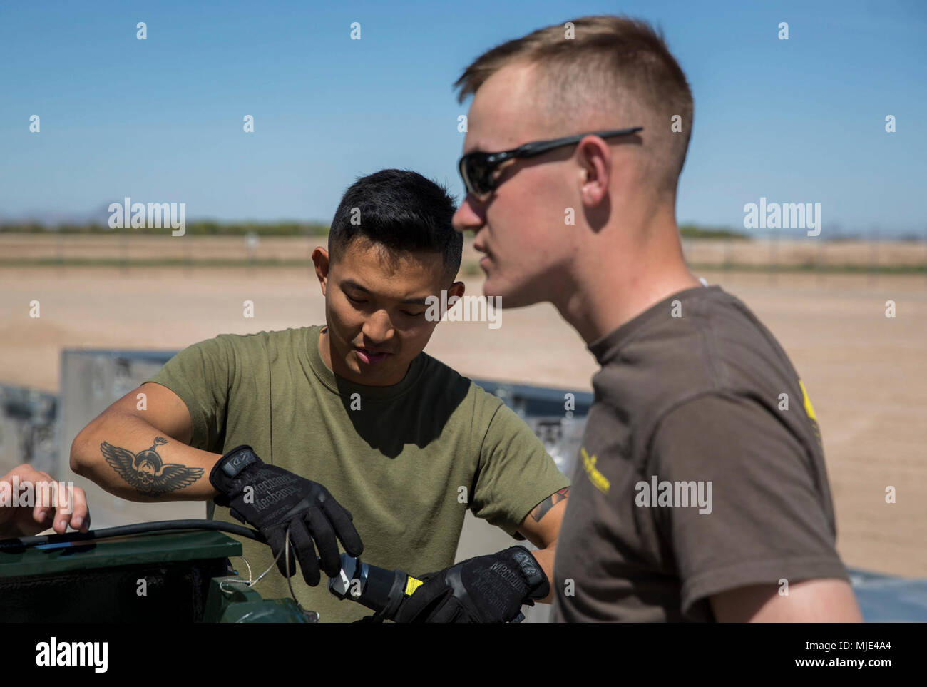 Sgt. Yonggam Espera, left, an aviation ordnance technician with Marine ...