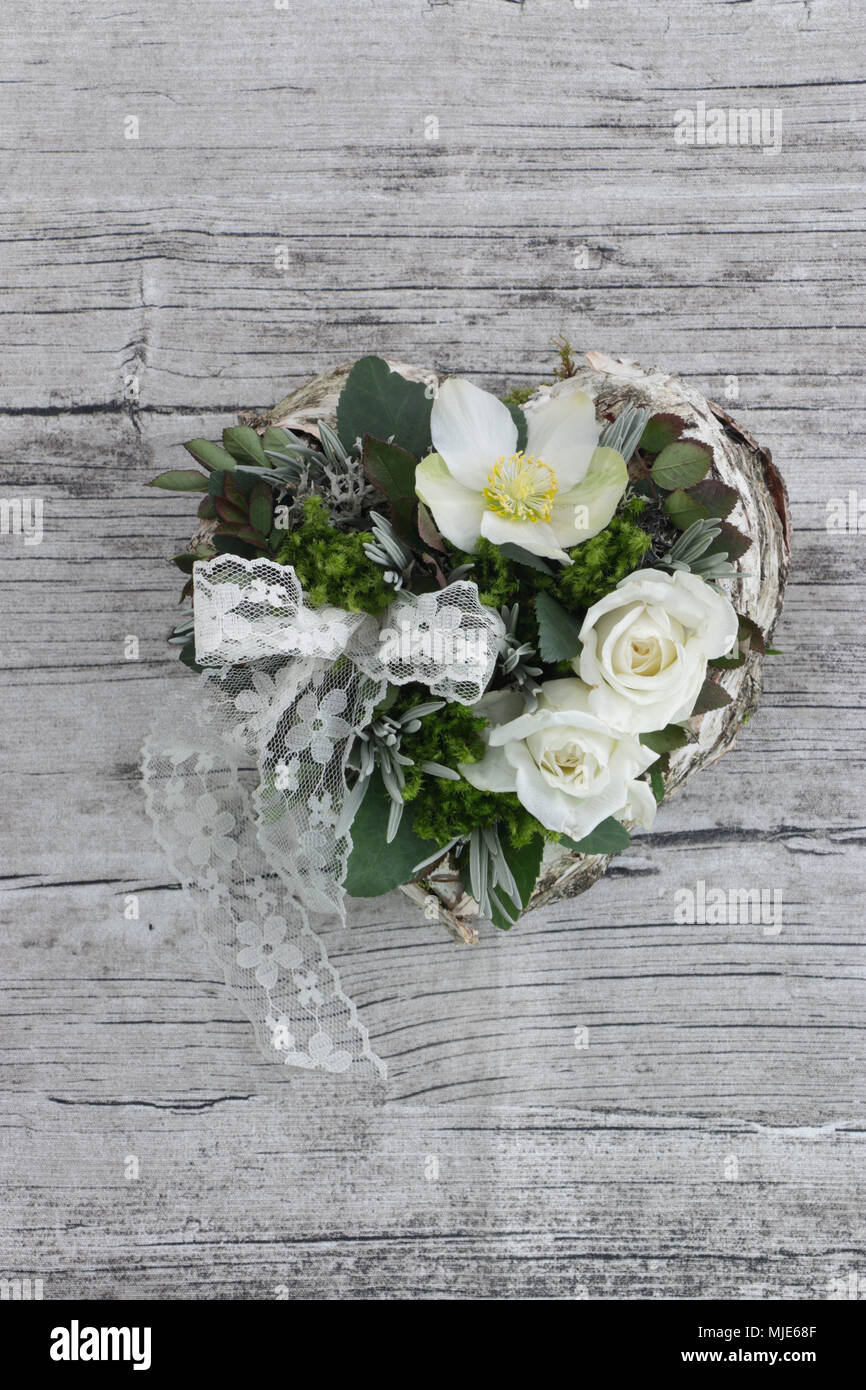 Heart winter magic with white roses and christmas rose hi-res stock ...