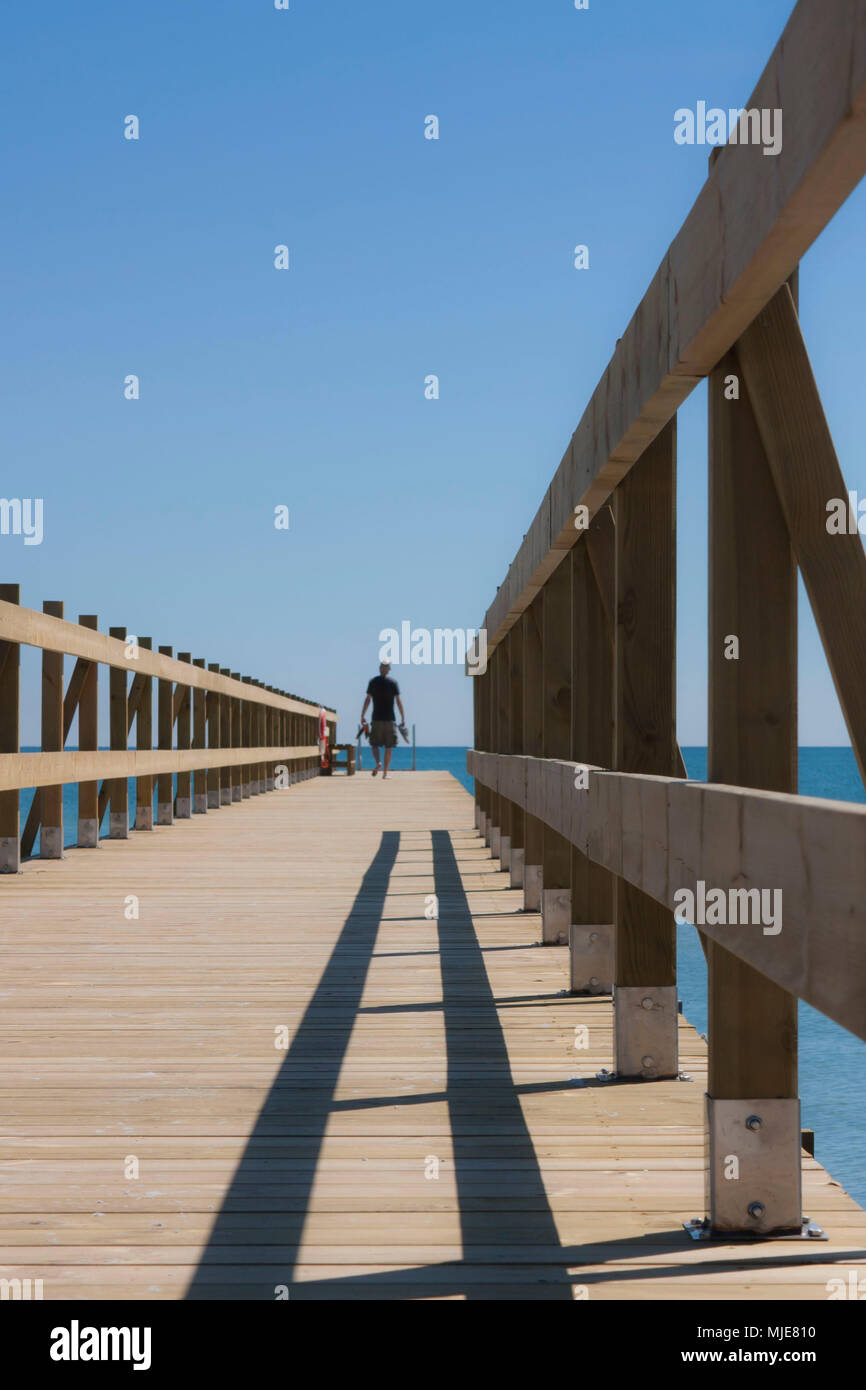 Man is running on jetty on the sea hi-res stock photography and images ...
