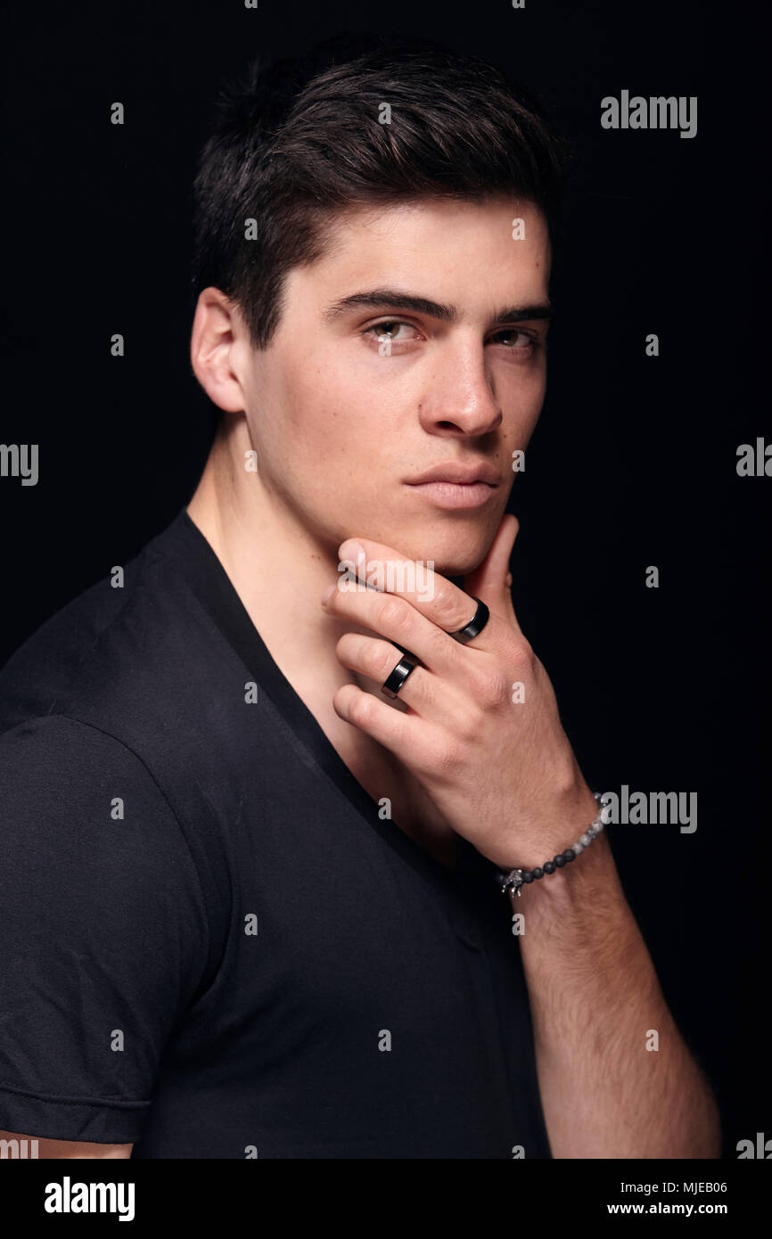 one young handsome man, model wearing t-shirt, simple studio upper body ...