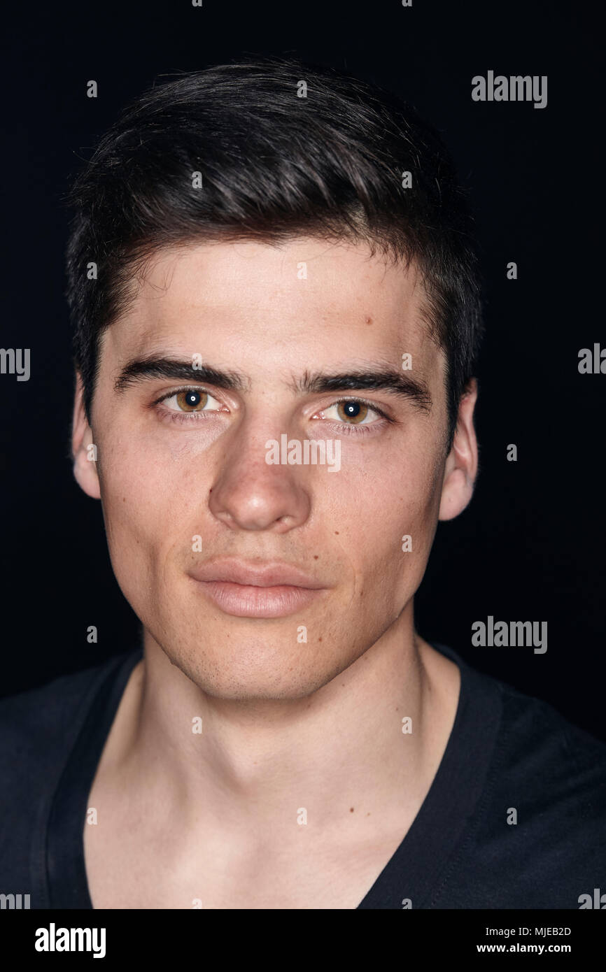 one young handsome man, model wearing t-shirt, simple studio upper body ...