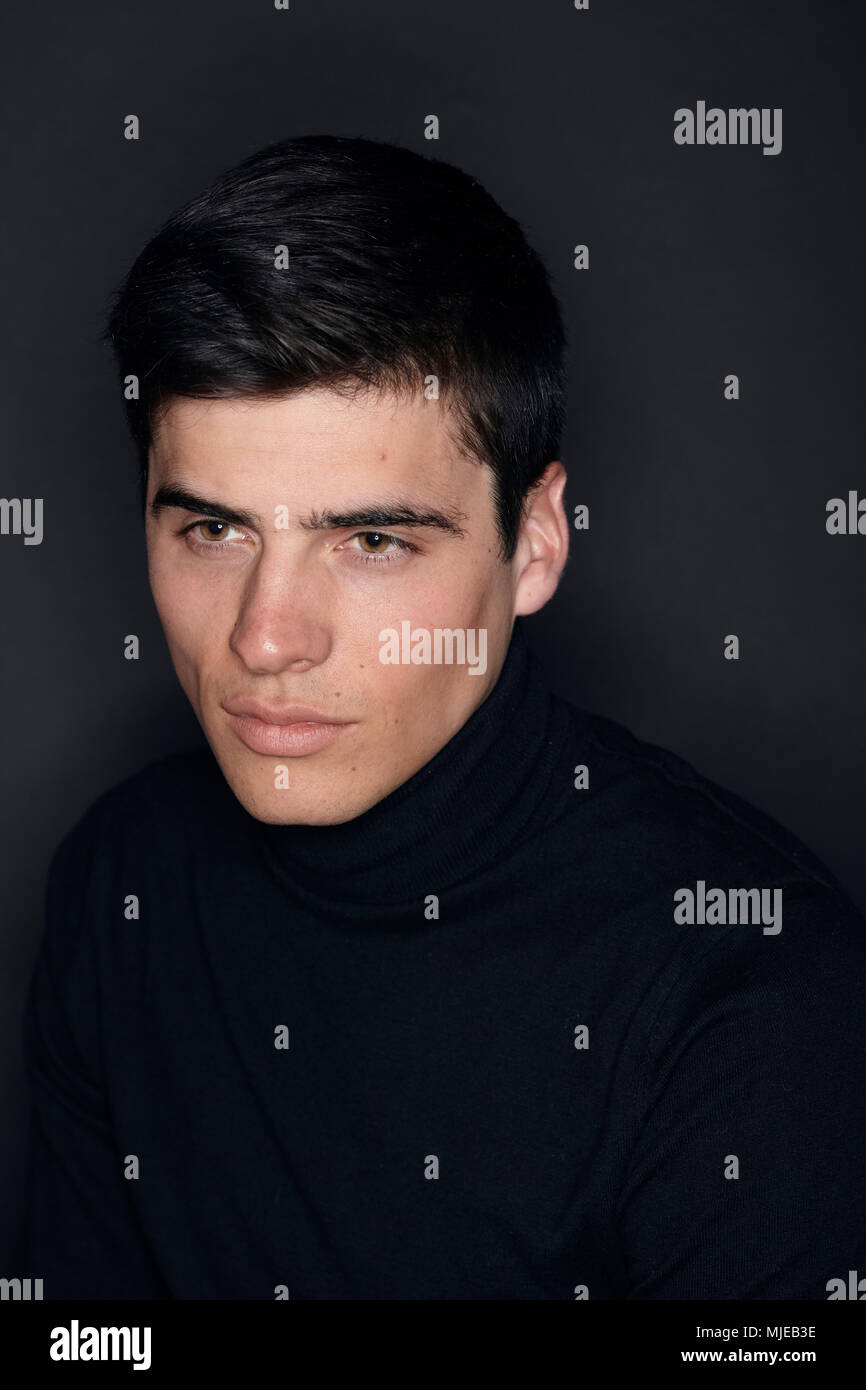 one young handsome man, model wearing turtleneck, simple studio upper ...