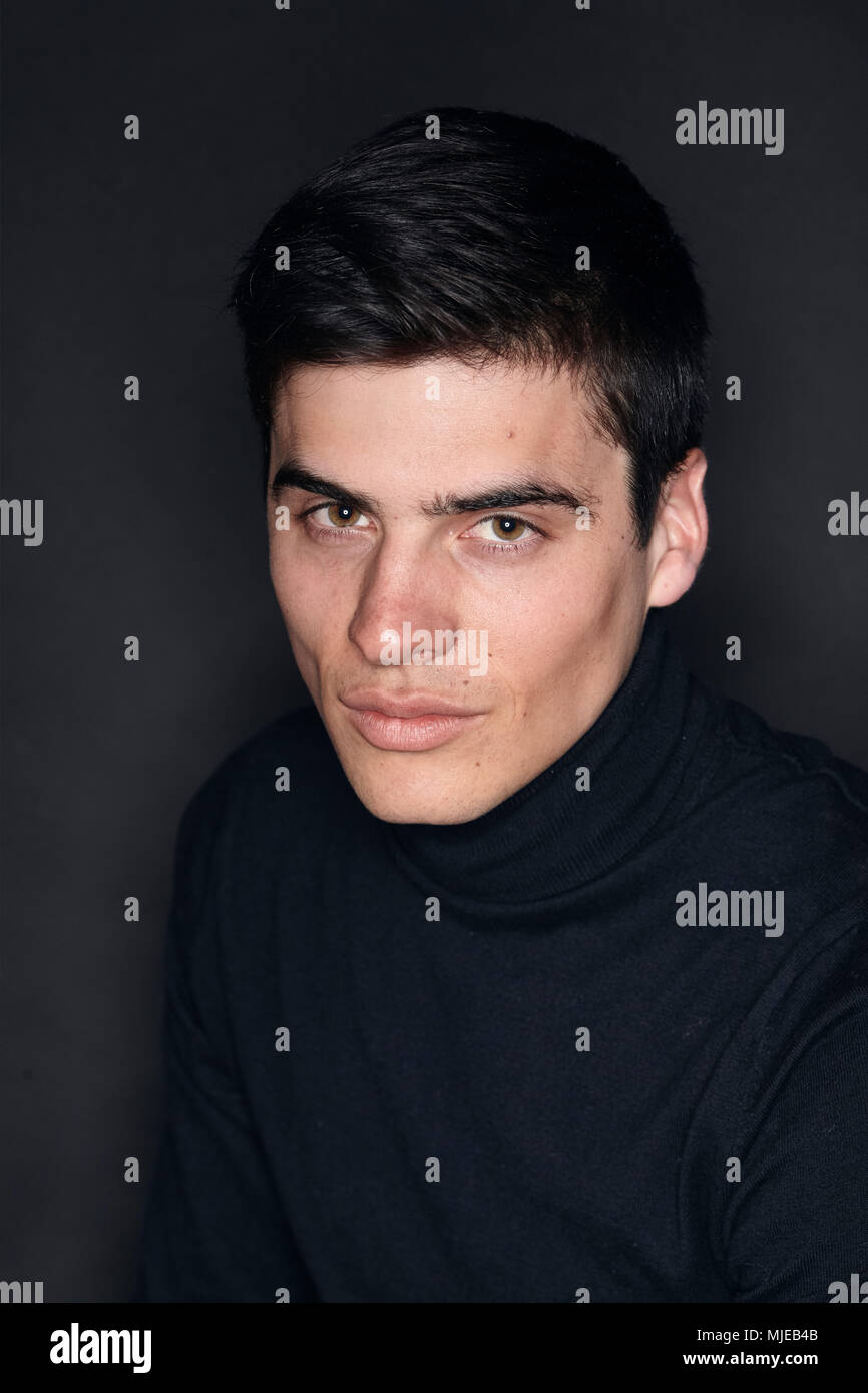 one young handsome man, model wearing turtleneck, simple studio upper ...