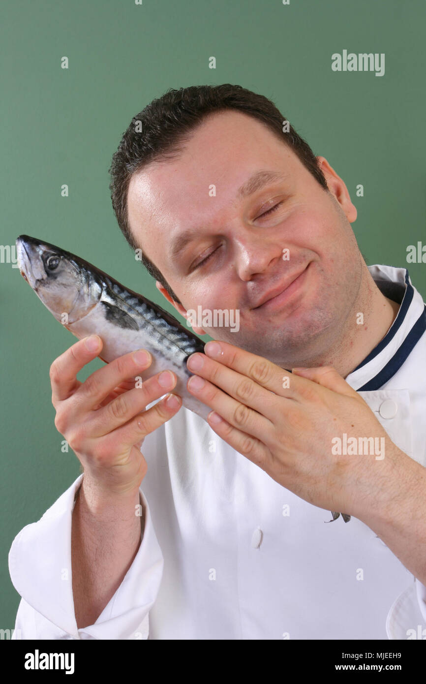 Chef hold fish and cuddle it with great emotion Stock Photo - Alamy