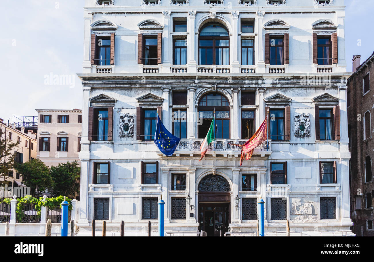 Three Flags on Old Marble Venice Building Stock Photo - Alamy